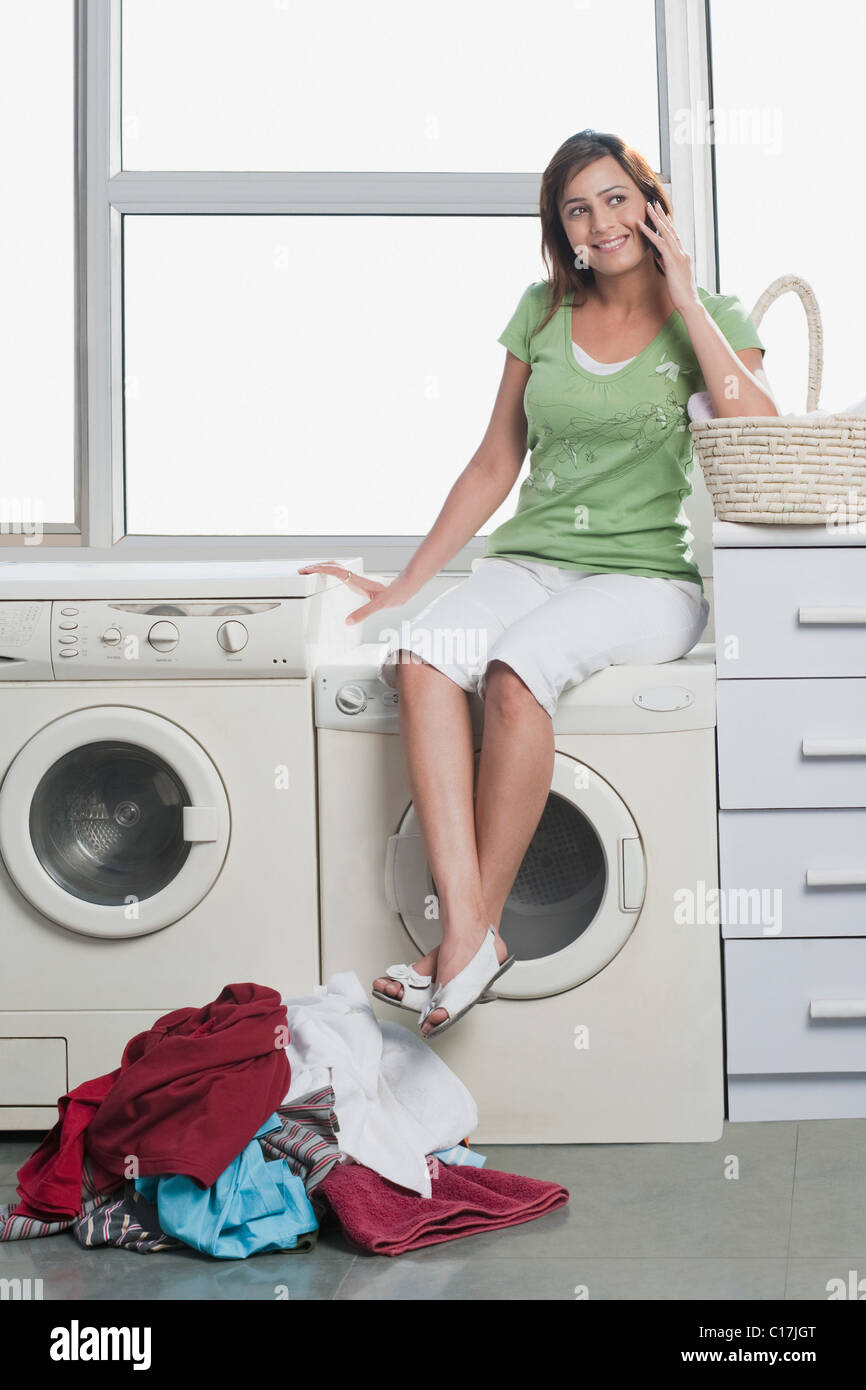 Sitting on the washing machine hi-res stock photography and images - Alamy