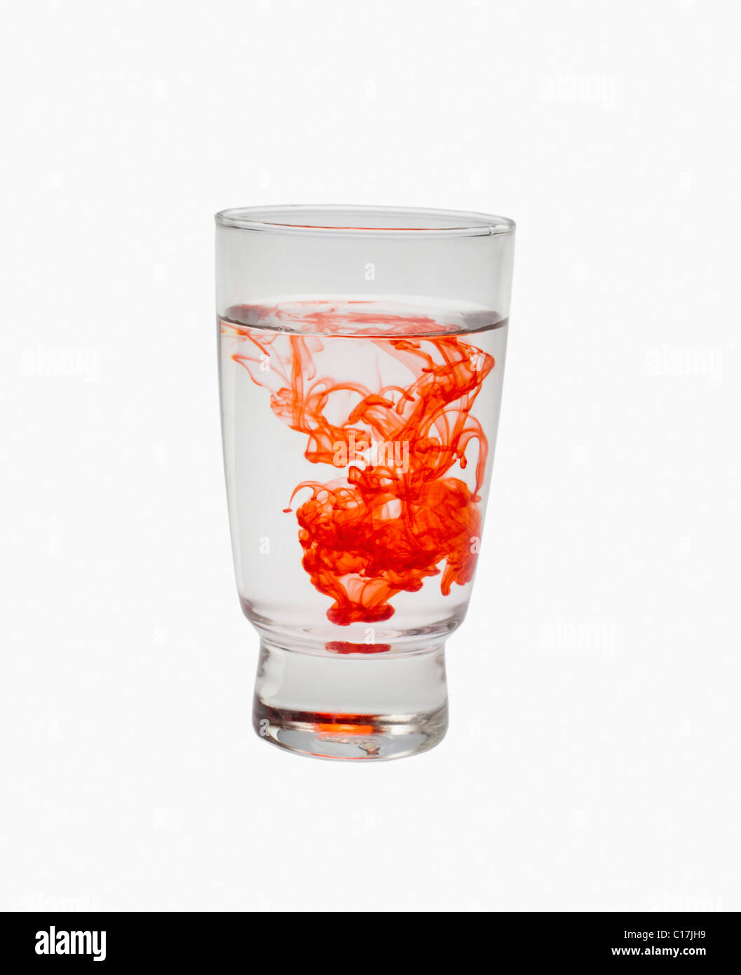 Fruit syrup mixing in a glass of water Stock Photo - Alamy