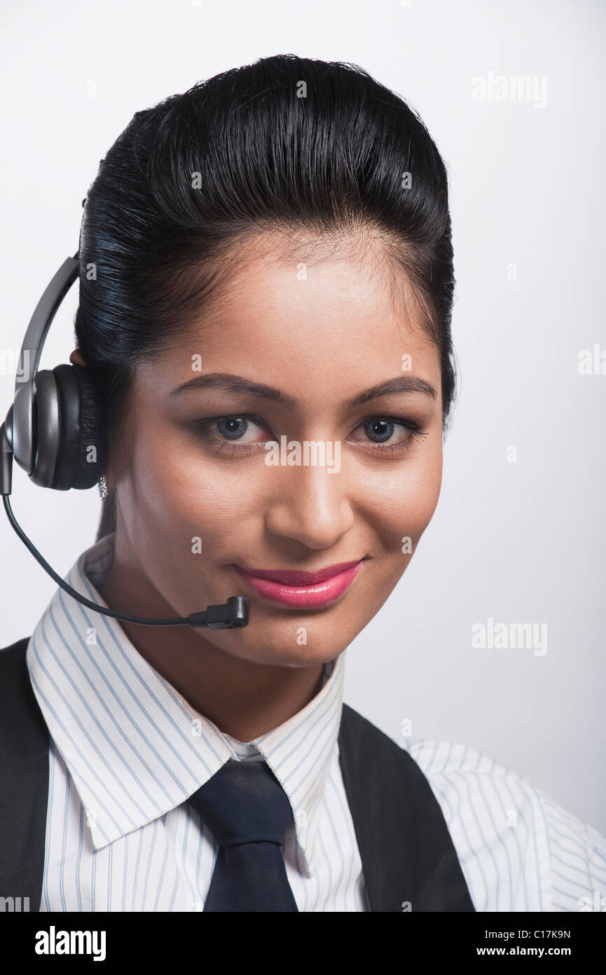 Portrait of a female customer service representative wearing a headset ...