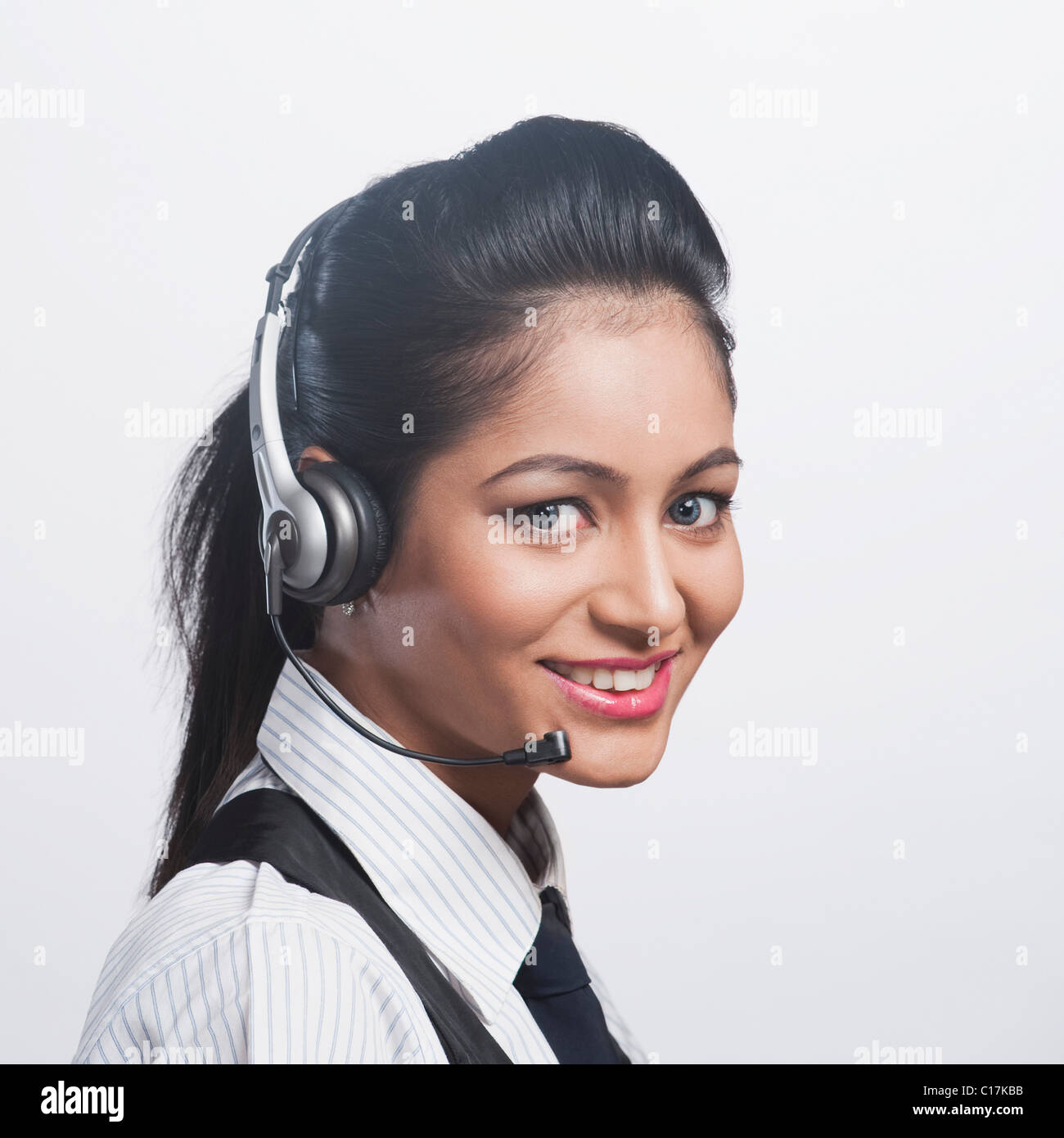 Portrait of a female customer service representative wearing a headset ...