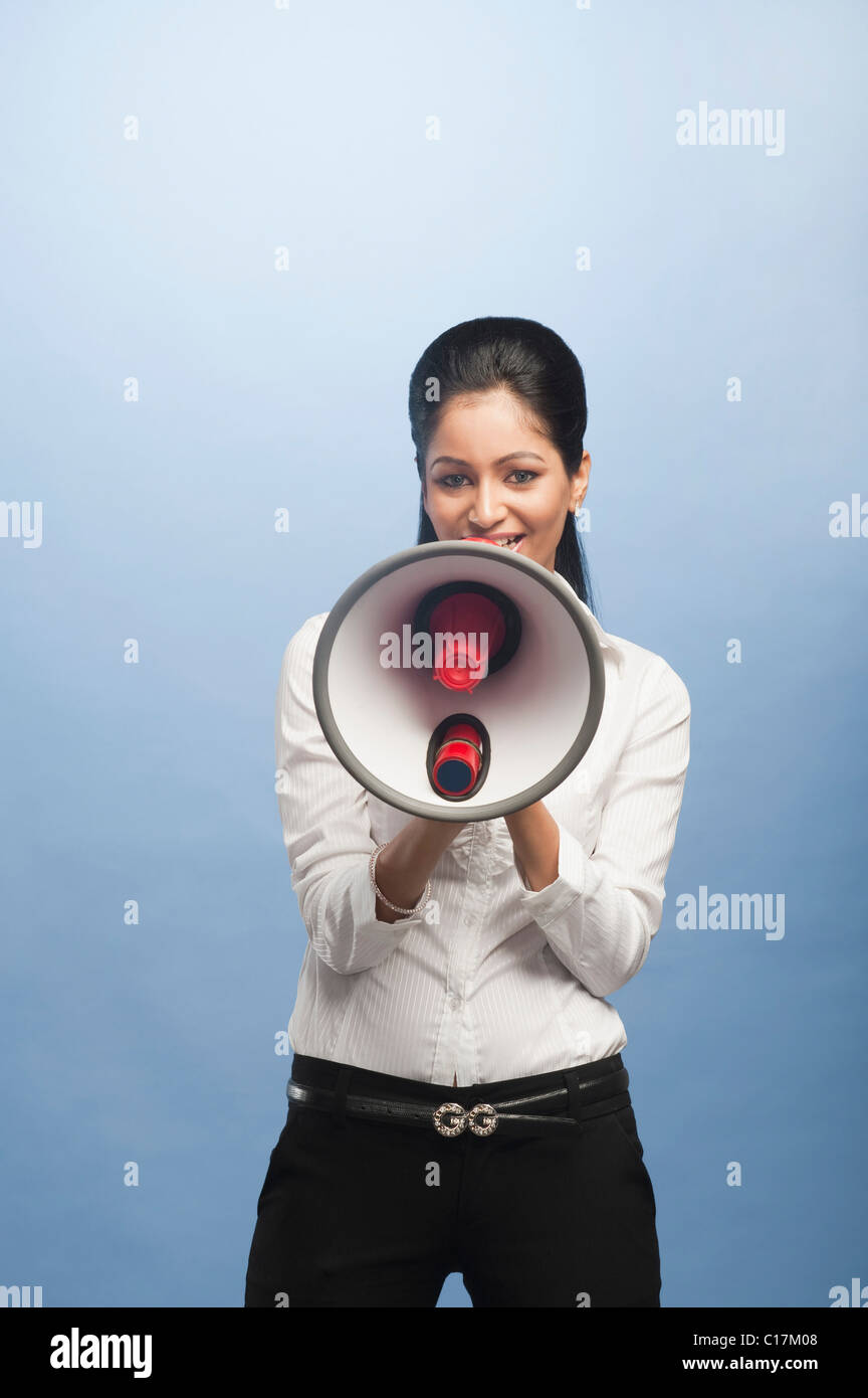 Businesswoman speaking into a megaphone Stock Photo - Alamy