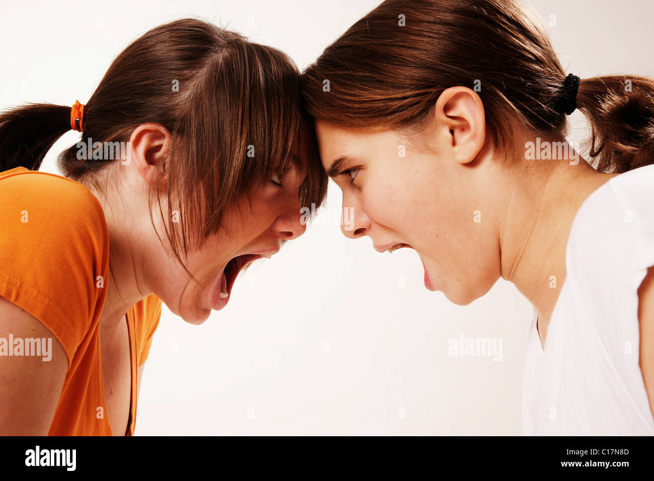 Two female teenagers shouting at each other Stock Photo - Alamy