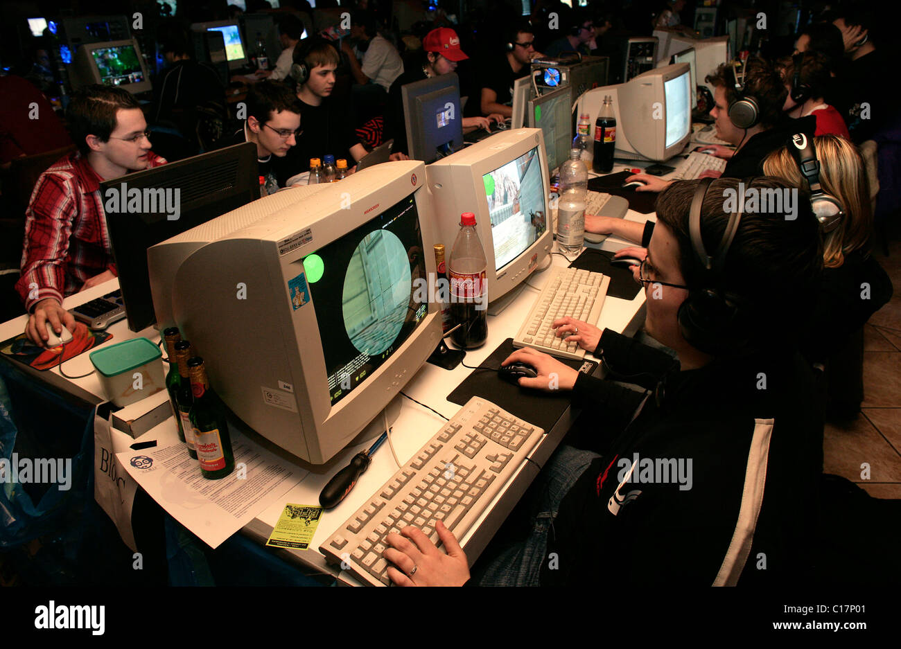 Participants Of A Lan Party Sitting In Front Of Computer Screens And Participants Of A Lan Party Sitting In Front Of Computer Screens And