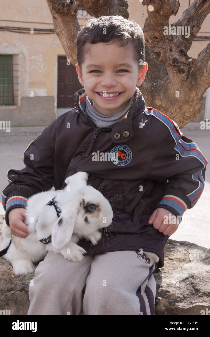 little boy with pet rabbit on lead Stock Photo - Alamy