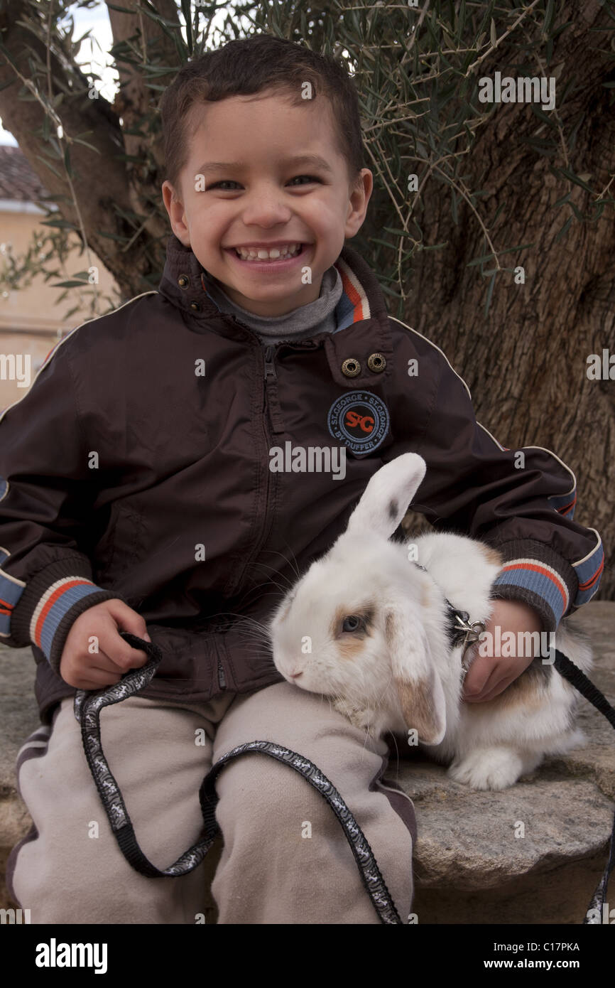 little boy with pet rabbit on lead Stock Photo - Alamy