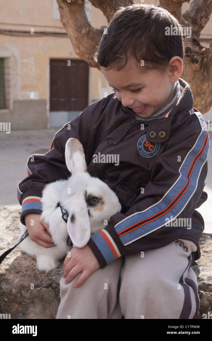 little boy with pet rabbit on lead Stock Photo - Alamy