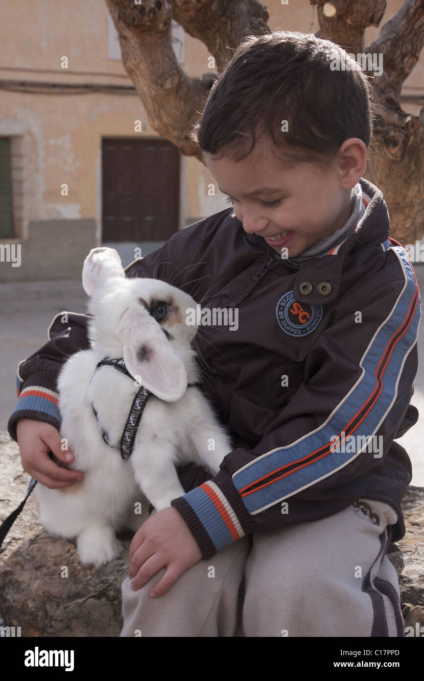 little boy with pet rabbit on lead Stock Photo - Alamy