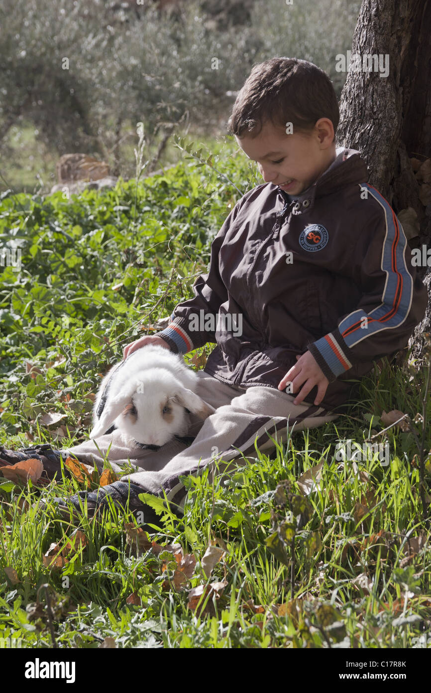 little boy with pet rabbit on lead Stock Photo - Alamy