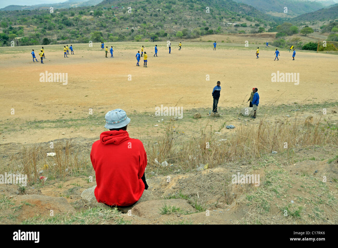 Spectators watching a soccer game on football pitch, Swaziland, Africa ...
