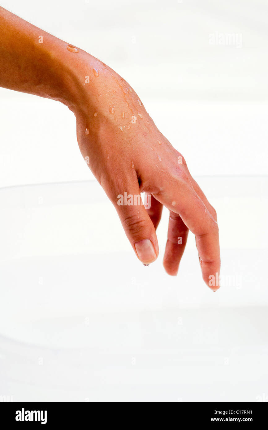 Woman dipping her hand into water Stock Photo - Alamy