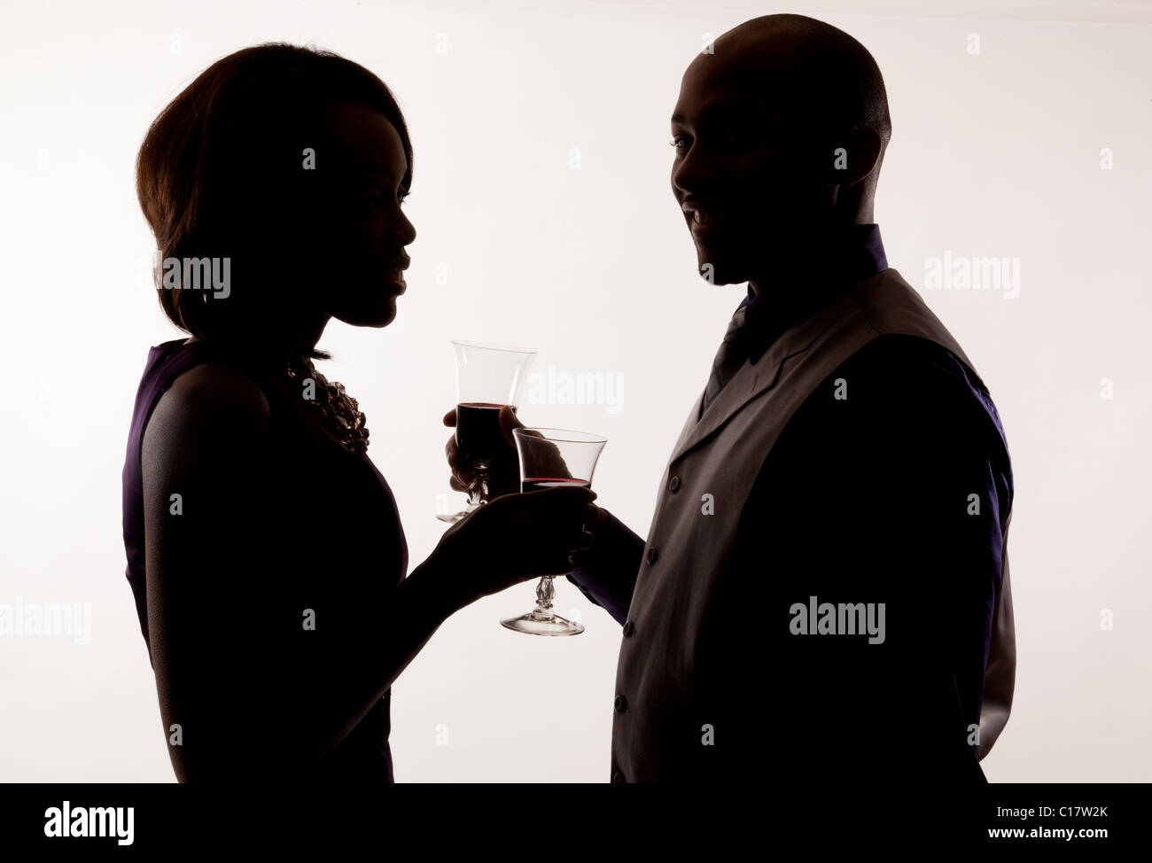 Silhouette of a man and a woman toasting with wine Stock Photo - Alamy