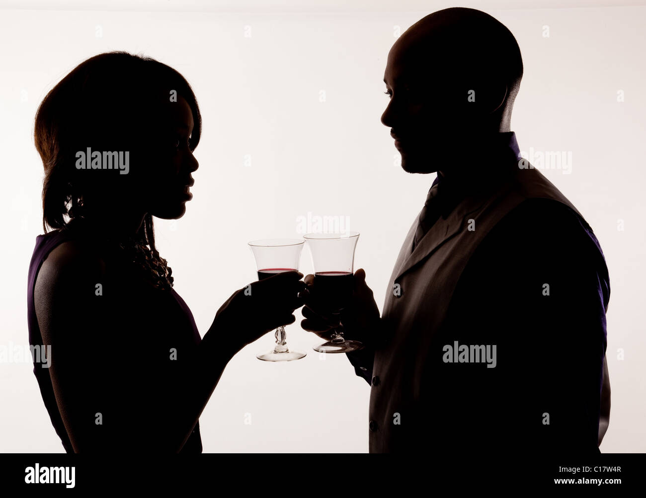 Silhouette of a man and a woman toasting with wine Stock Photo - Alamy