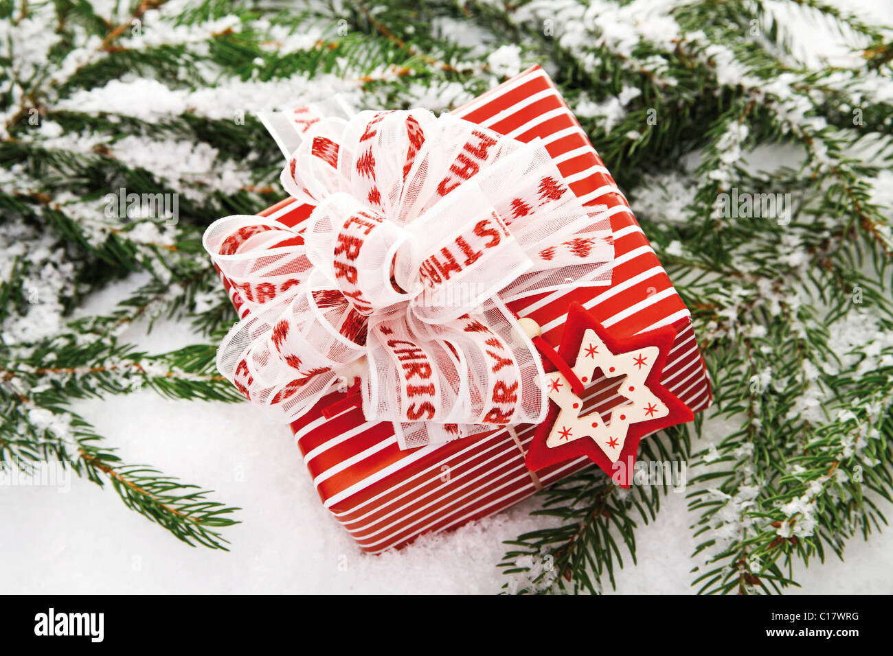 Christmas present on snow with branches of fir Stock Photo - Alamy