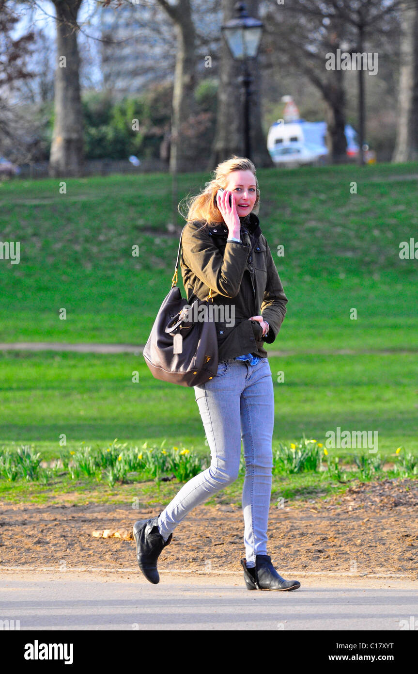 Young Woman Talking into mobile phone in Hyde Park, London Stock Photo ...