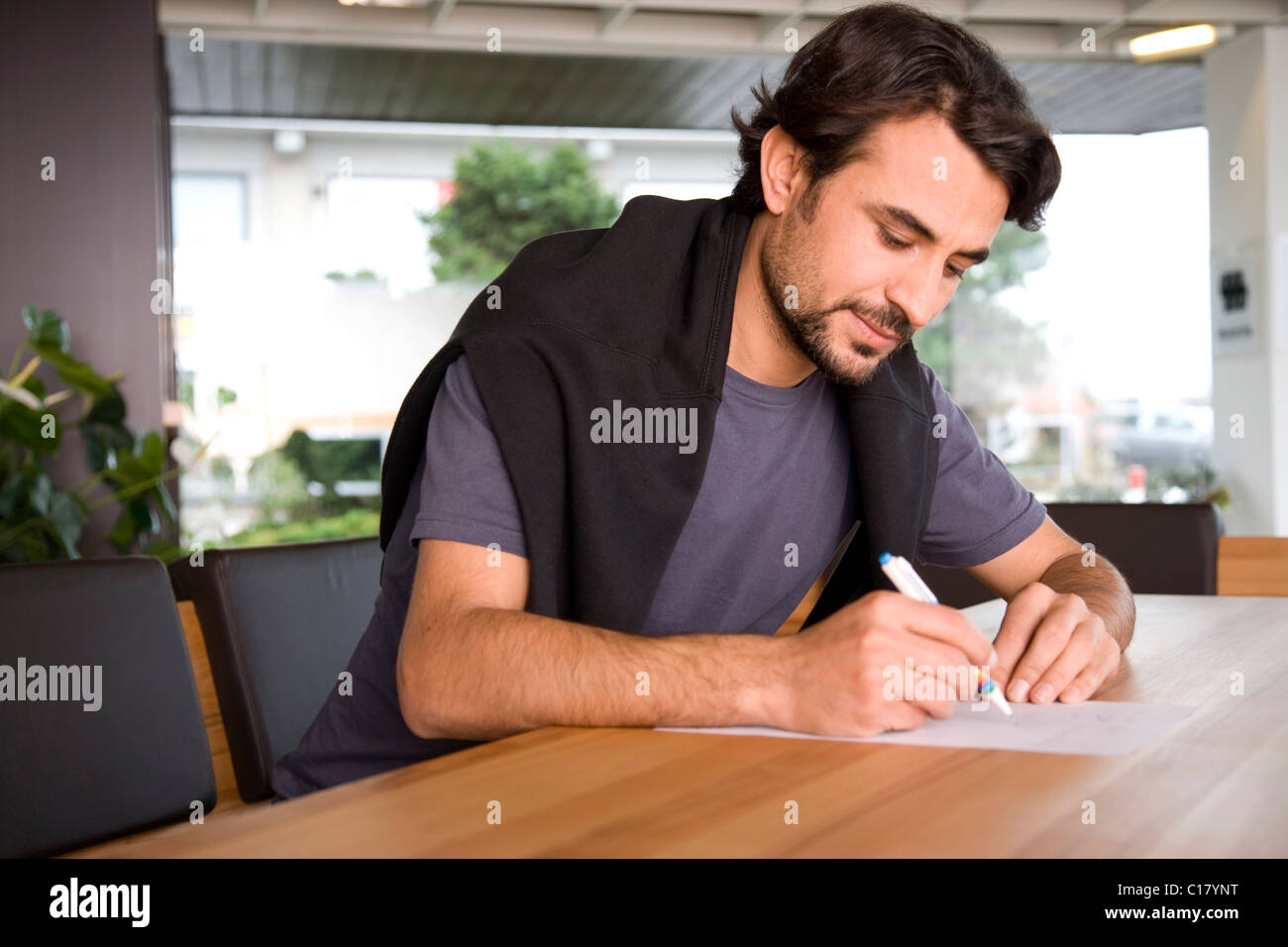 Man filling in a form Stock Photo - Alamy