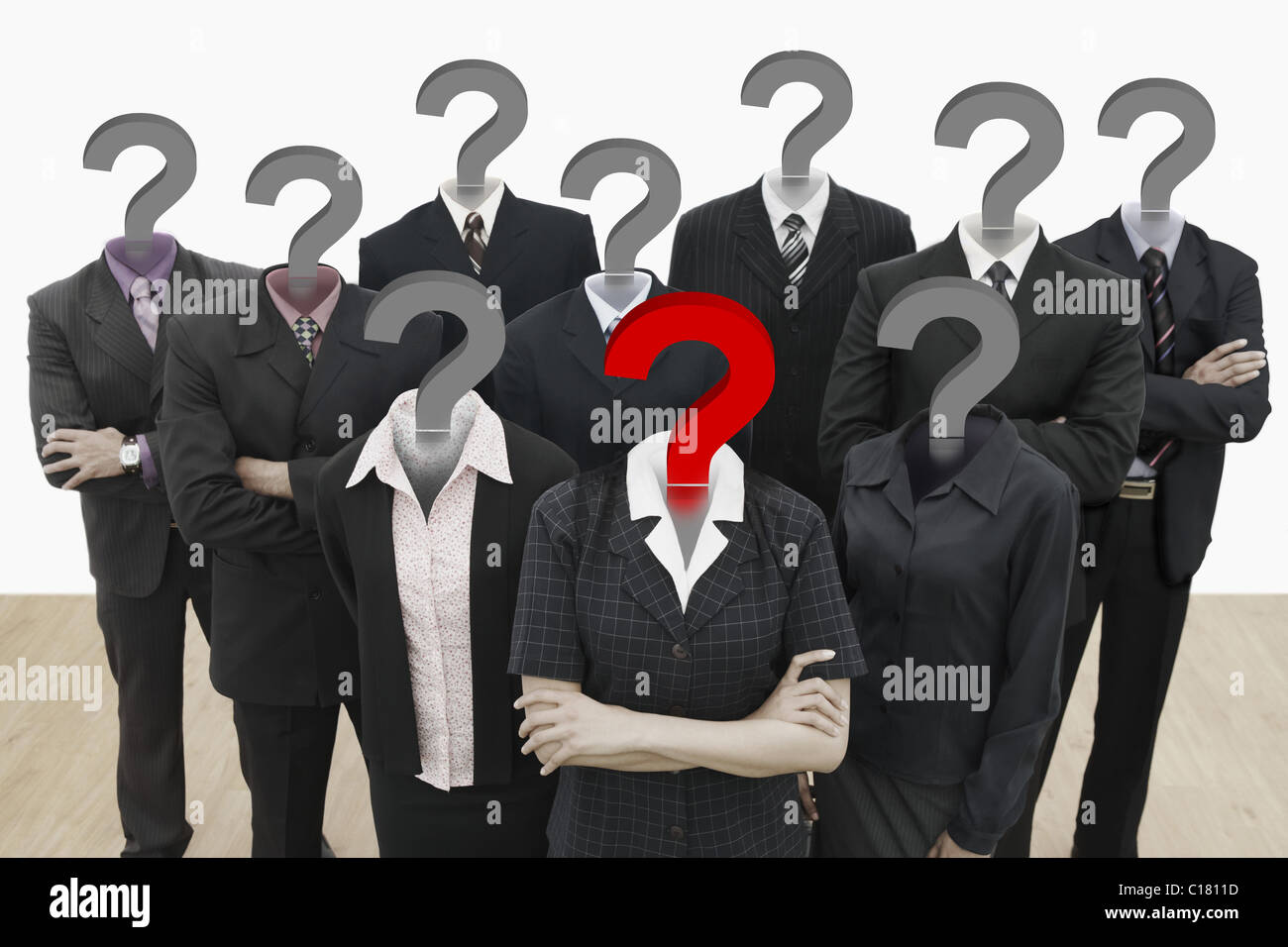 Business executives with question marks faces standing with their arms ...