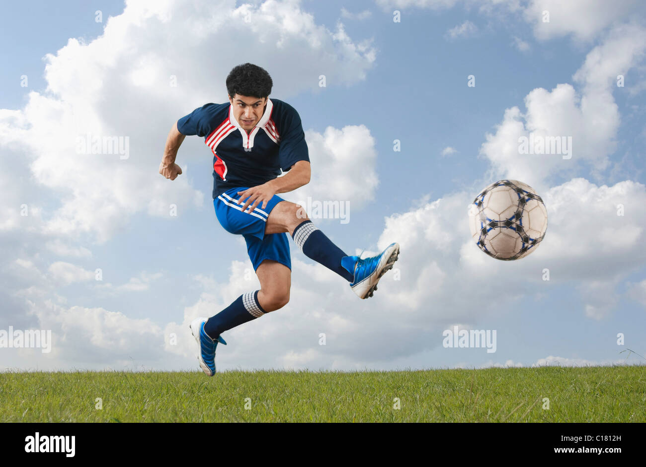 Soccer player kicking a soccer ball Stock Photo - Alamy