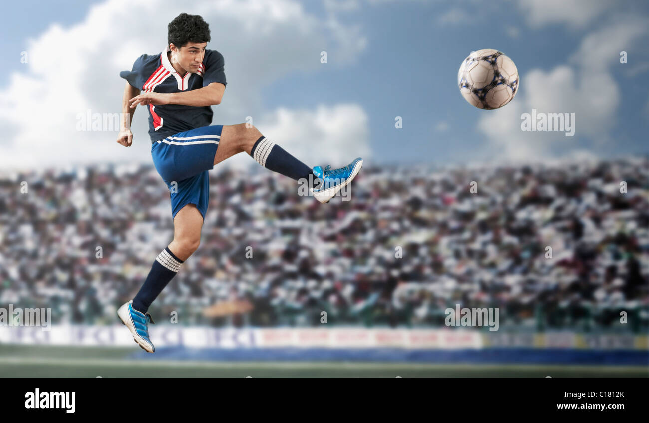 Soccer player kicking a soccer ball Stock Photo - Alamy