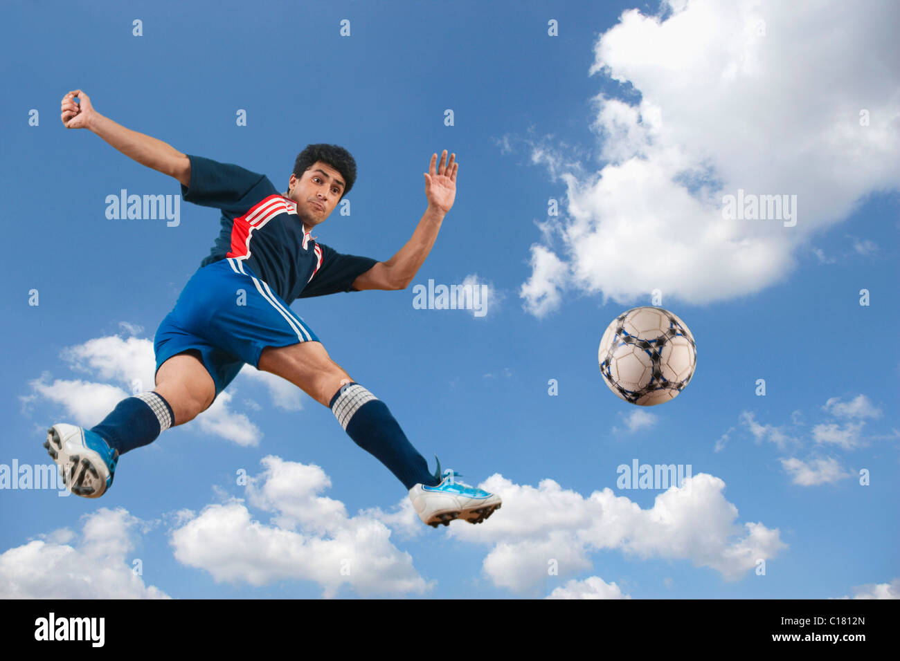 Soccer player kicking a soccer ball Stock Photo - Alamy