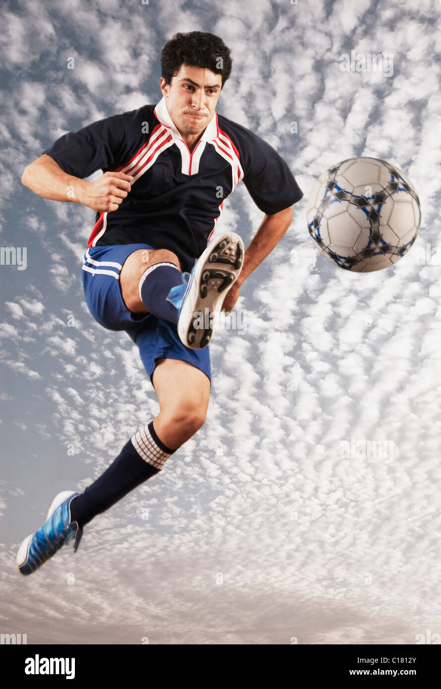 Soccer player kicking a soccer ball Stock Photo - Alamy