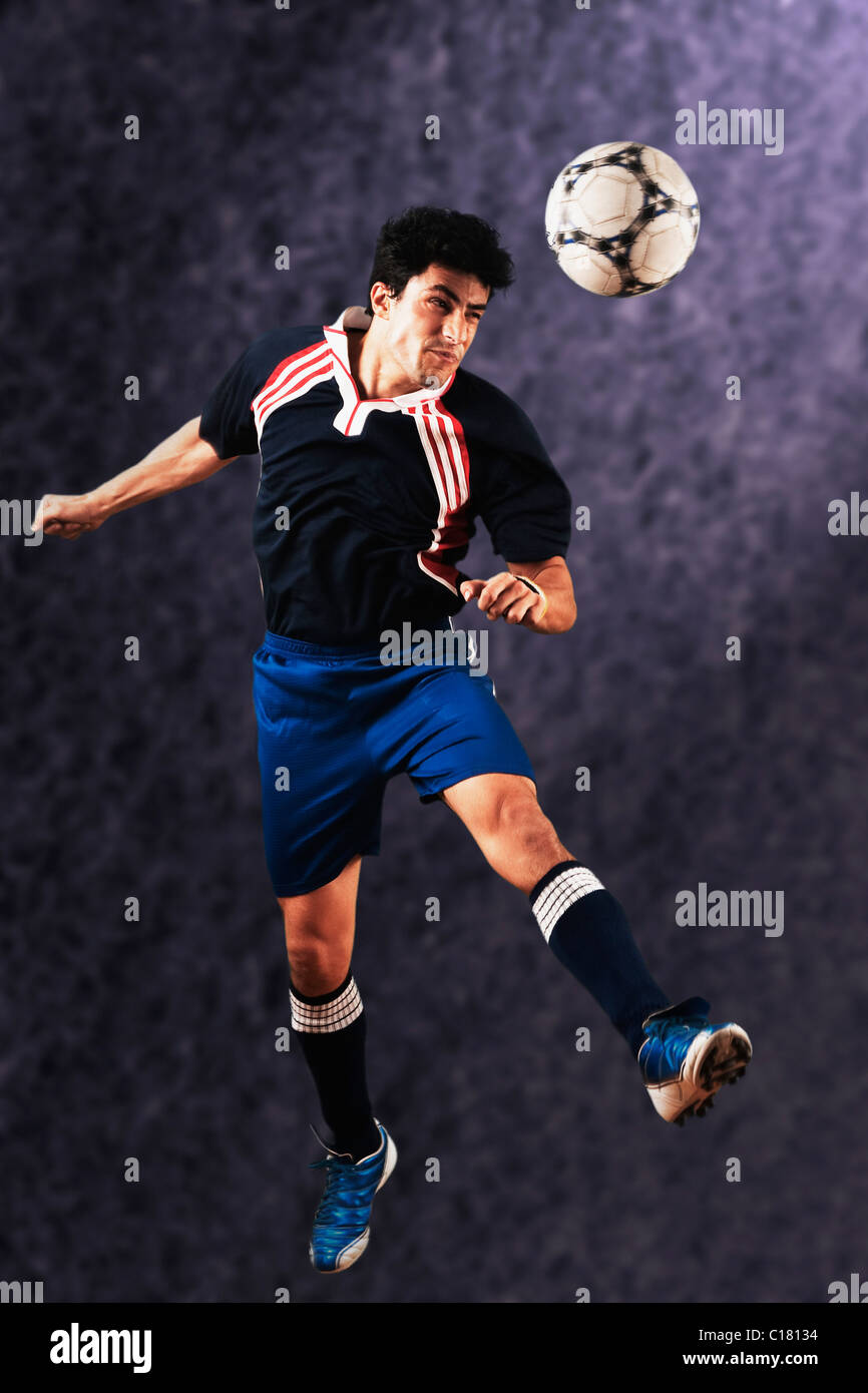 Soccer player heading a soccer ball Stock Photo - Alamy