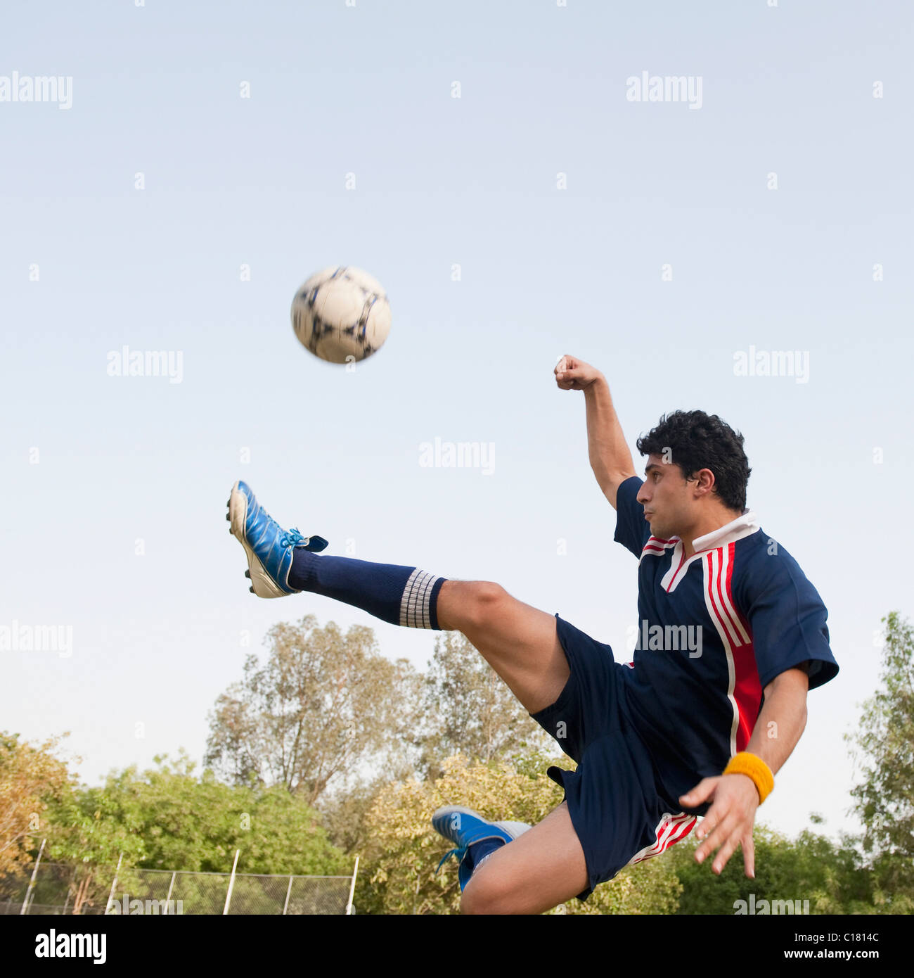 Soccer player kicking a soccer ball Stock Photo - Alamy