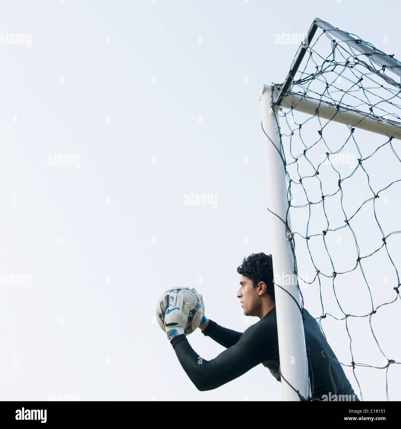 Young man catching ball at goal post hi-res stock photography and ...