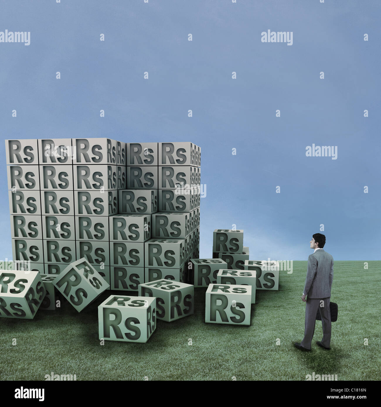 Businessman standing in front of money blocks Stock Photo - Alamy
