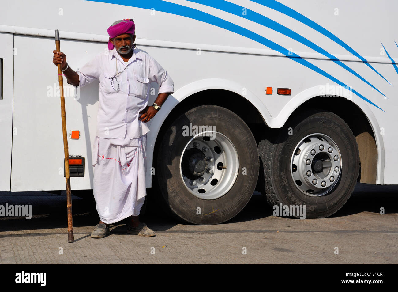 A man from Gujarat with stick guarding a vehicle Stock Photo - Alamy