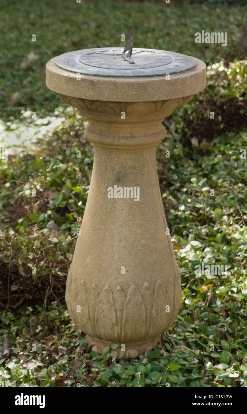 Classic ornamental sundial in a garden surrounded by ivy Stock Photo ...