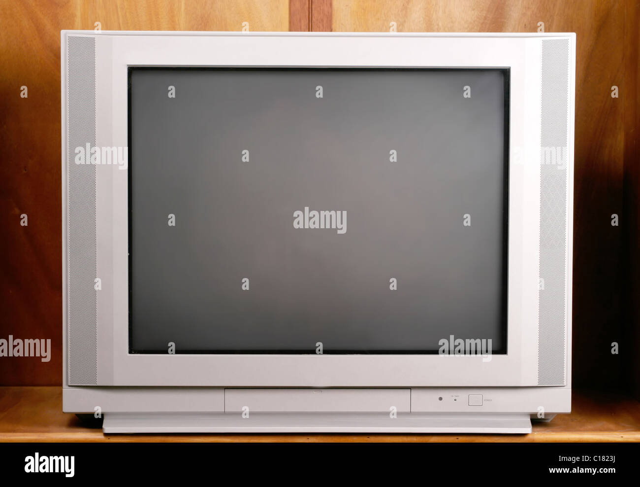 Ordinary and commonplace 27 inch flatscreen television in a wood ...