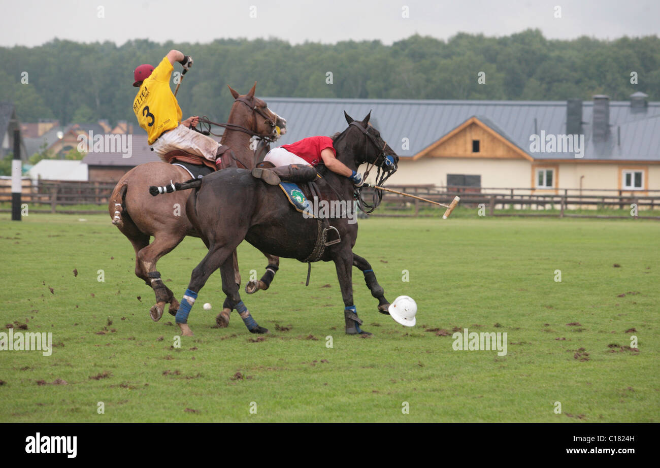 Polo riders falls off horses Stock Photo - Alamy