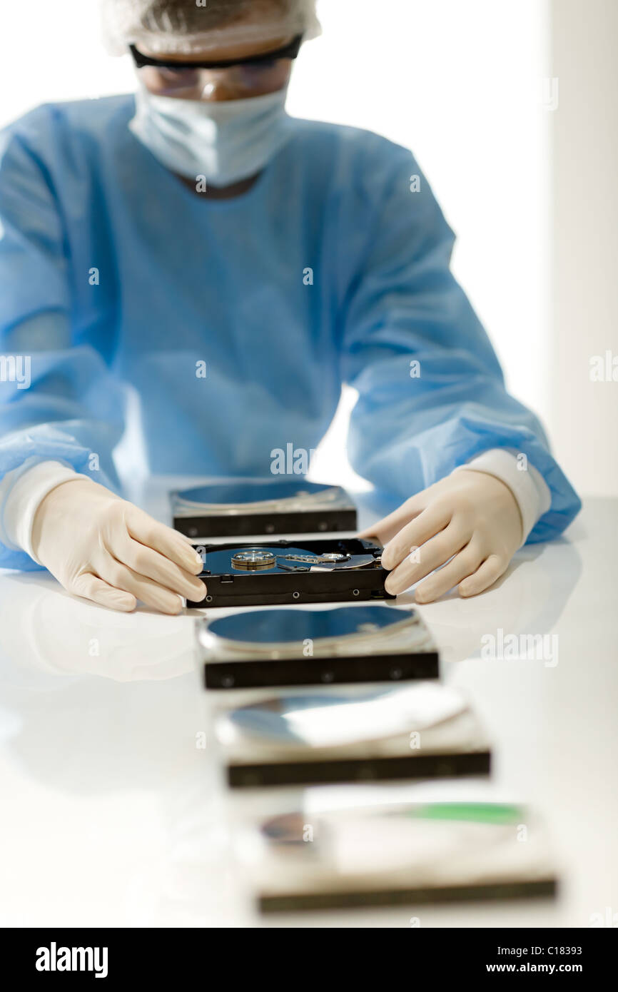 Female computer engineer repair hard disc defect, experiment in sterile ...