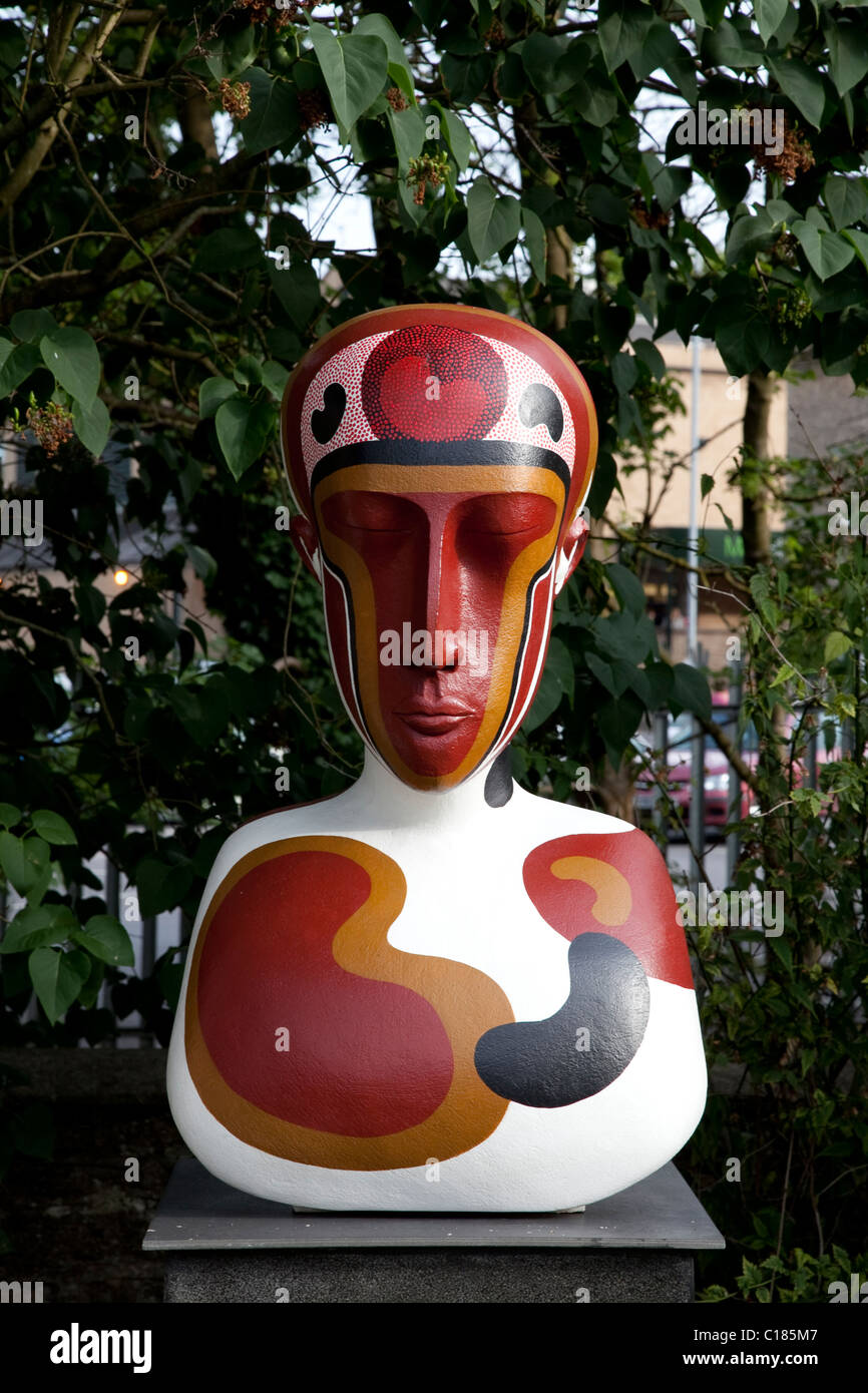 Wooden painted coloured garden sculpture Stock Photo - Alamy