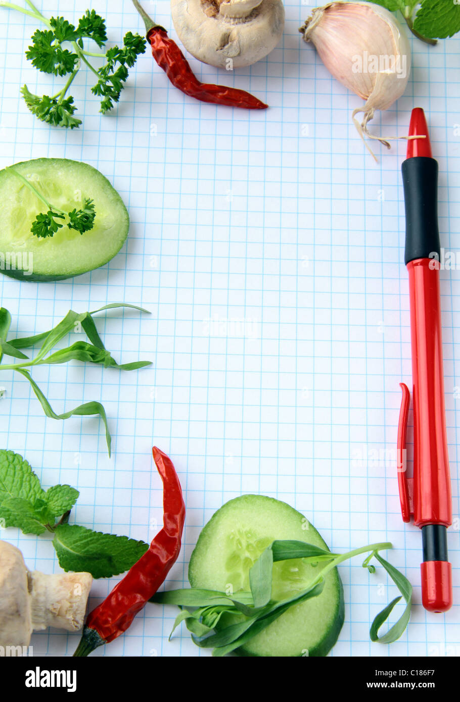 notebook with a pen and fresh spices and vegetables for a menu or ...