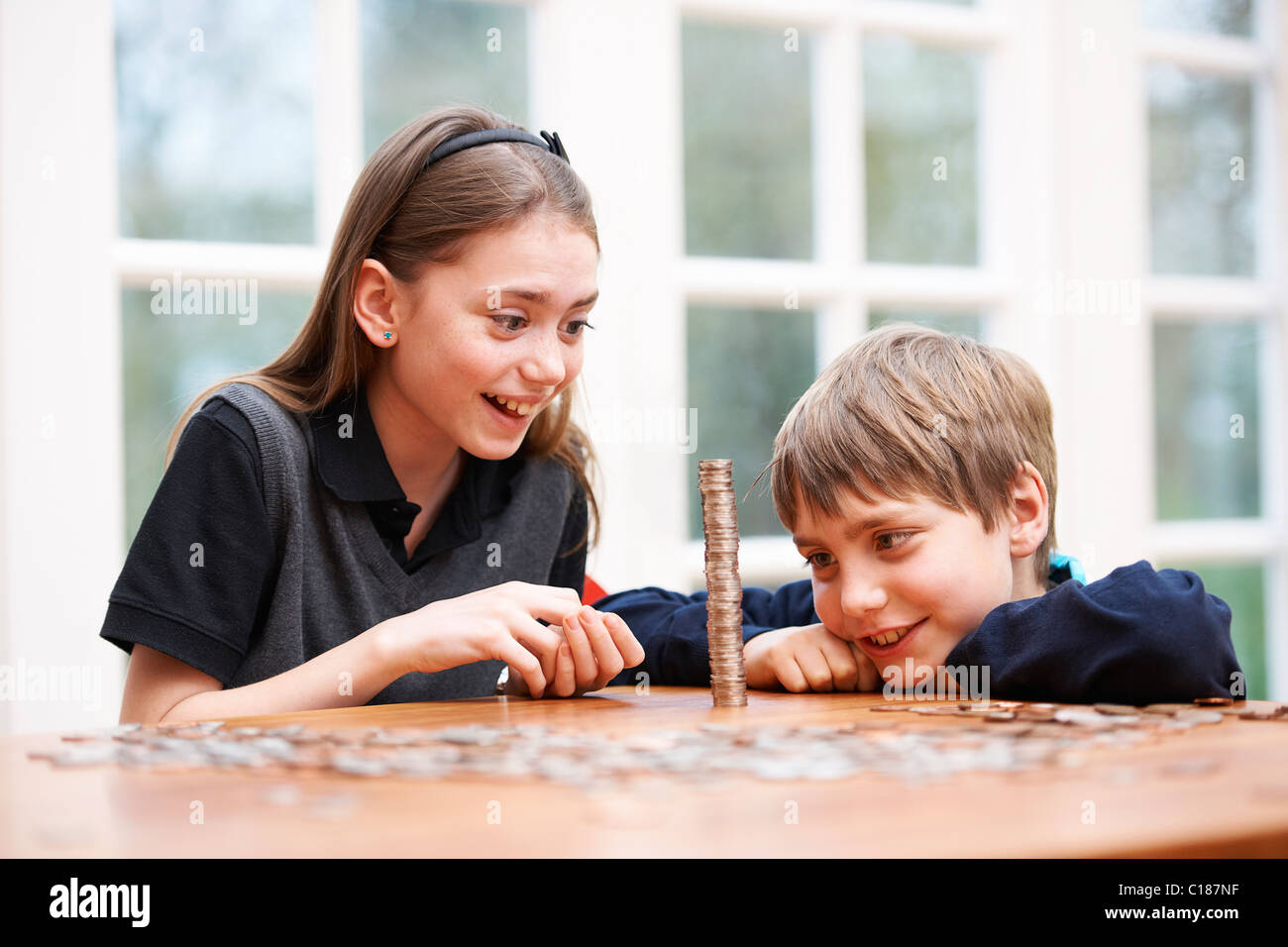 Children counting piles of money Stock Photo - Alamy