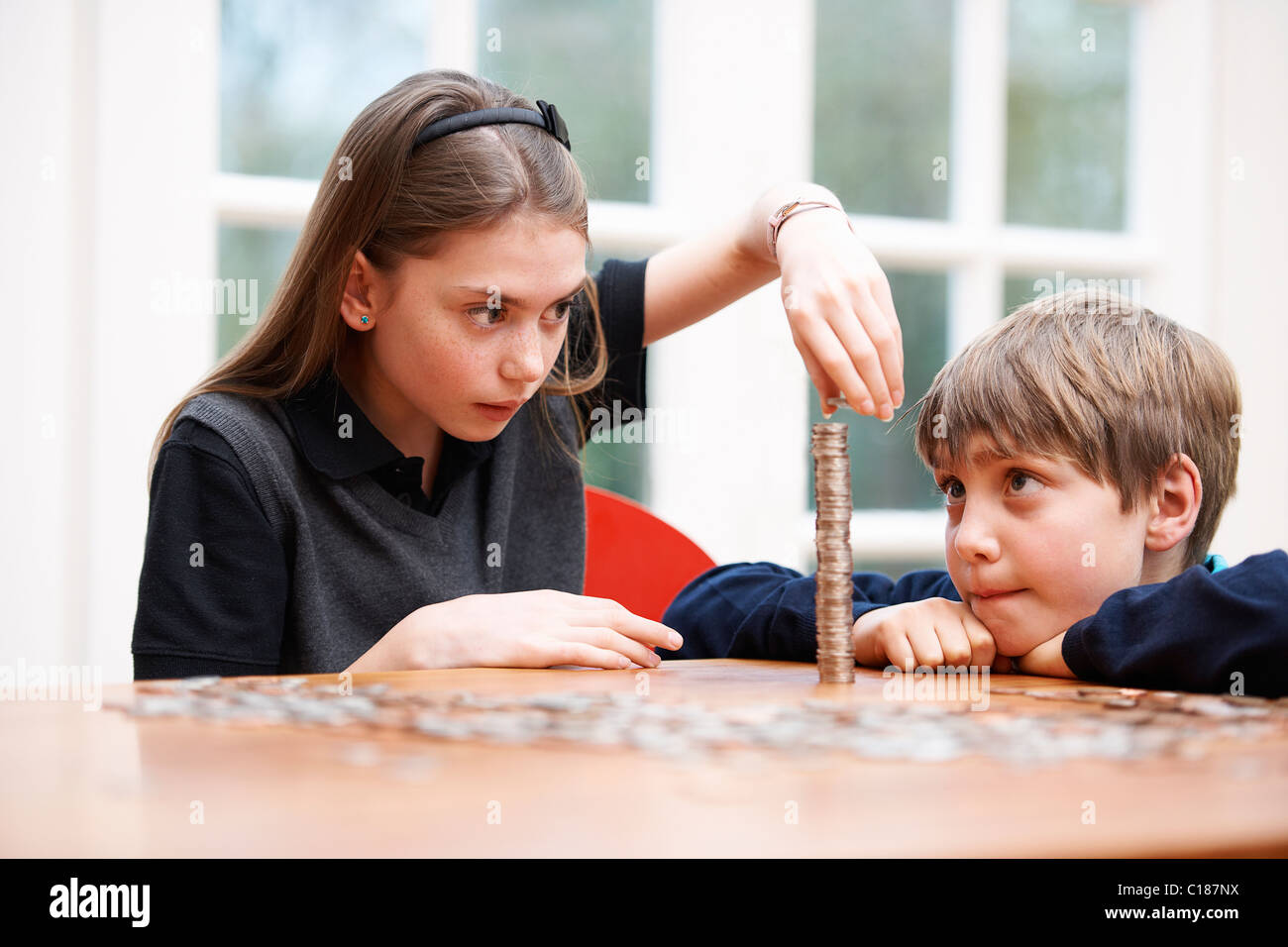 Children counting piles of money Stock Photo - Alamy