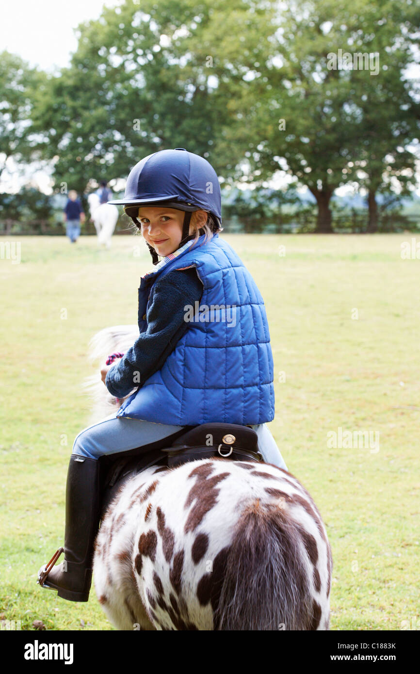 Young girl riding her pony Stock Photo - Alamy