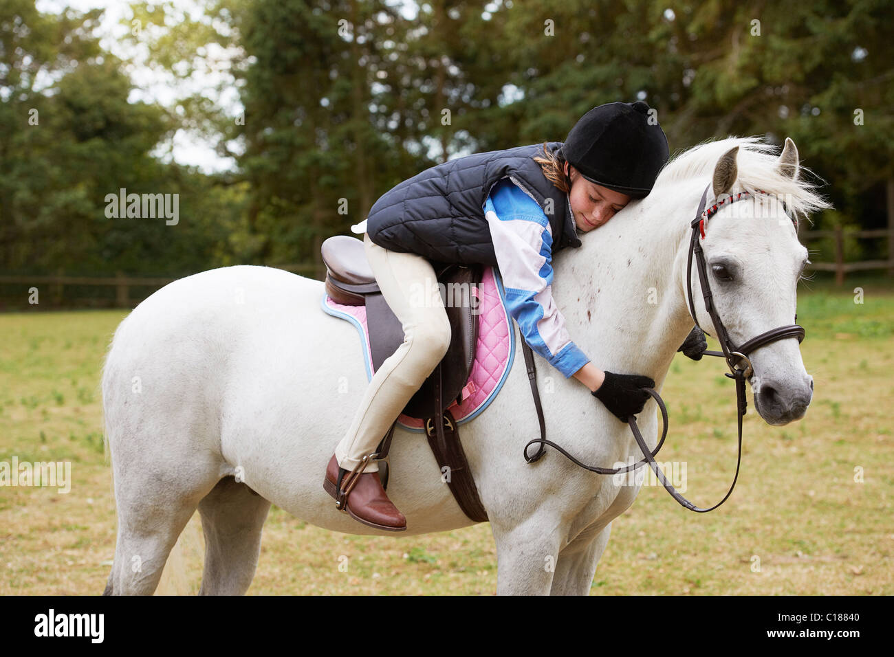 Girl cuddling her pony Stock Photo - Alamy