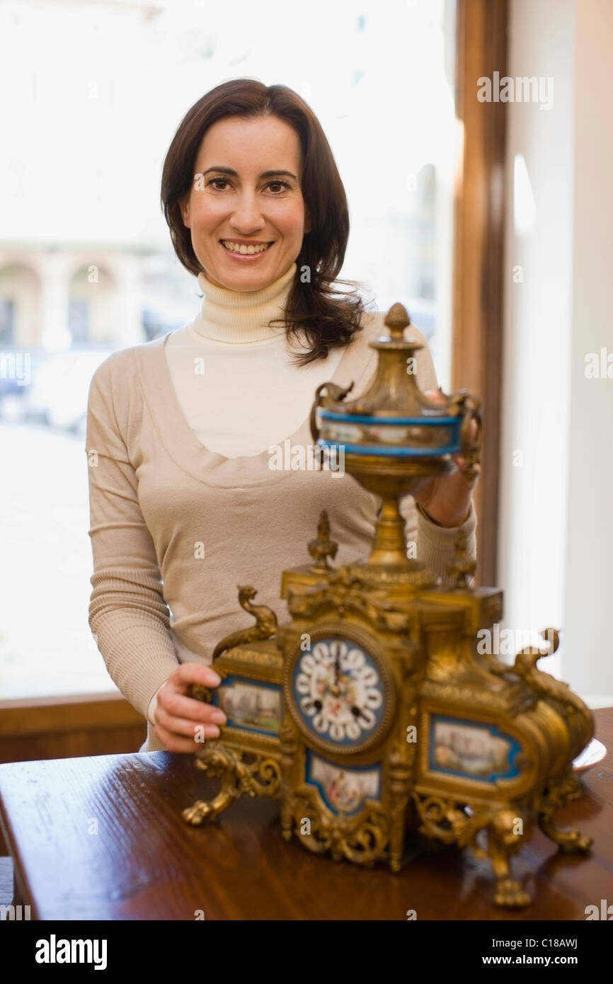Woman with antique clock Stock Photo - Alamy