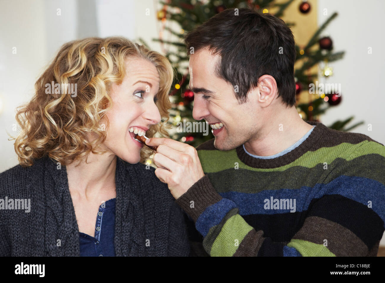 Man feeding cookie woman hi-res stock photography and images - Alamy
