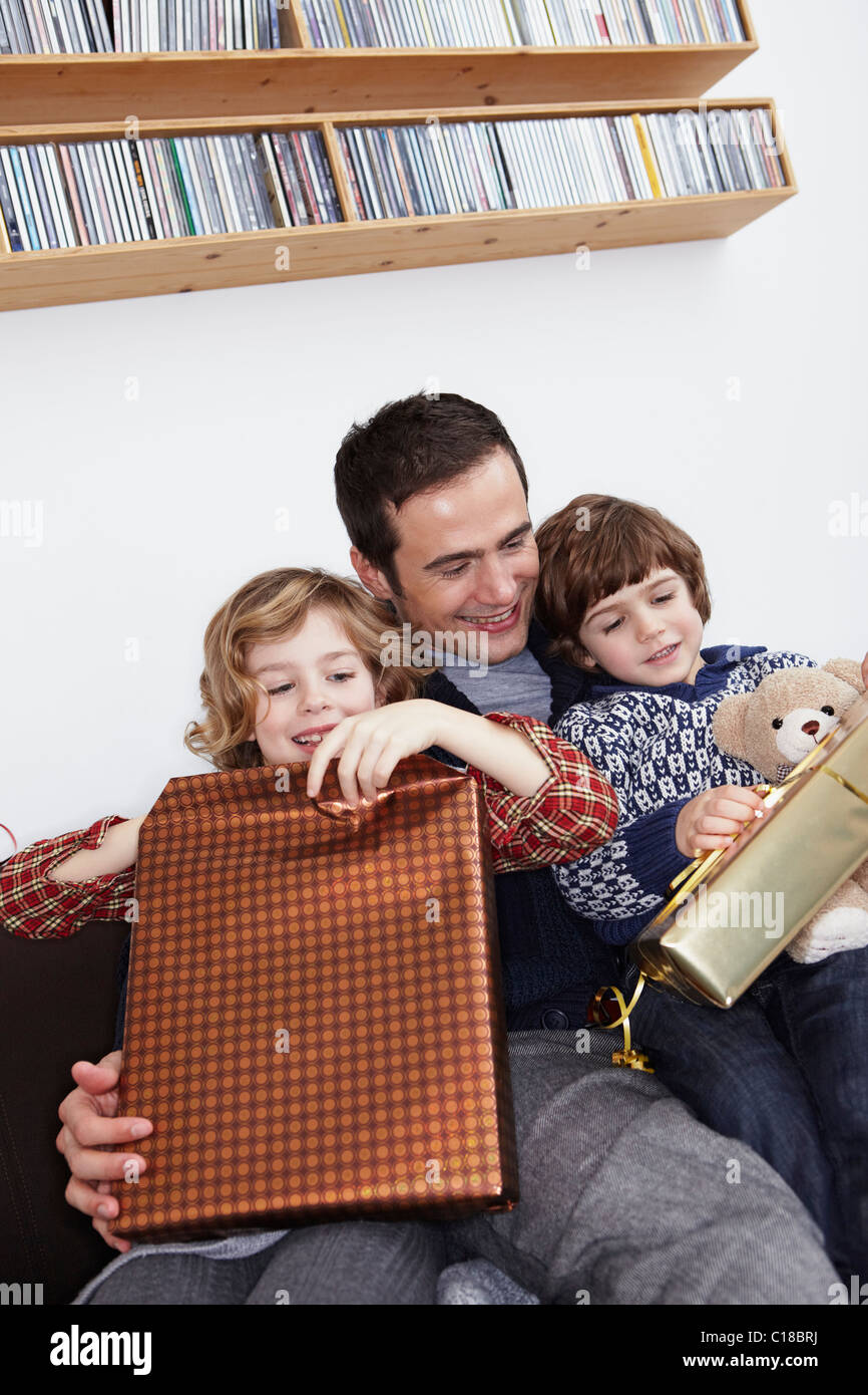 Father and Kids opening gifts Stock Photo - Alamy