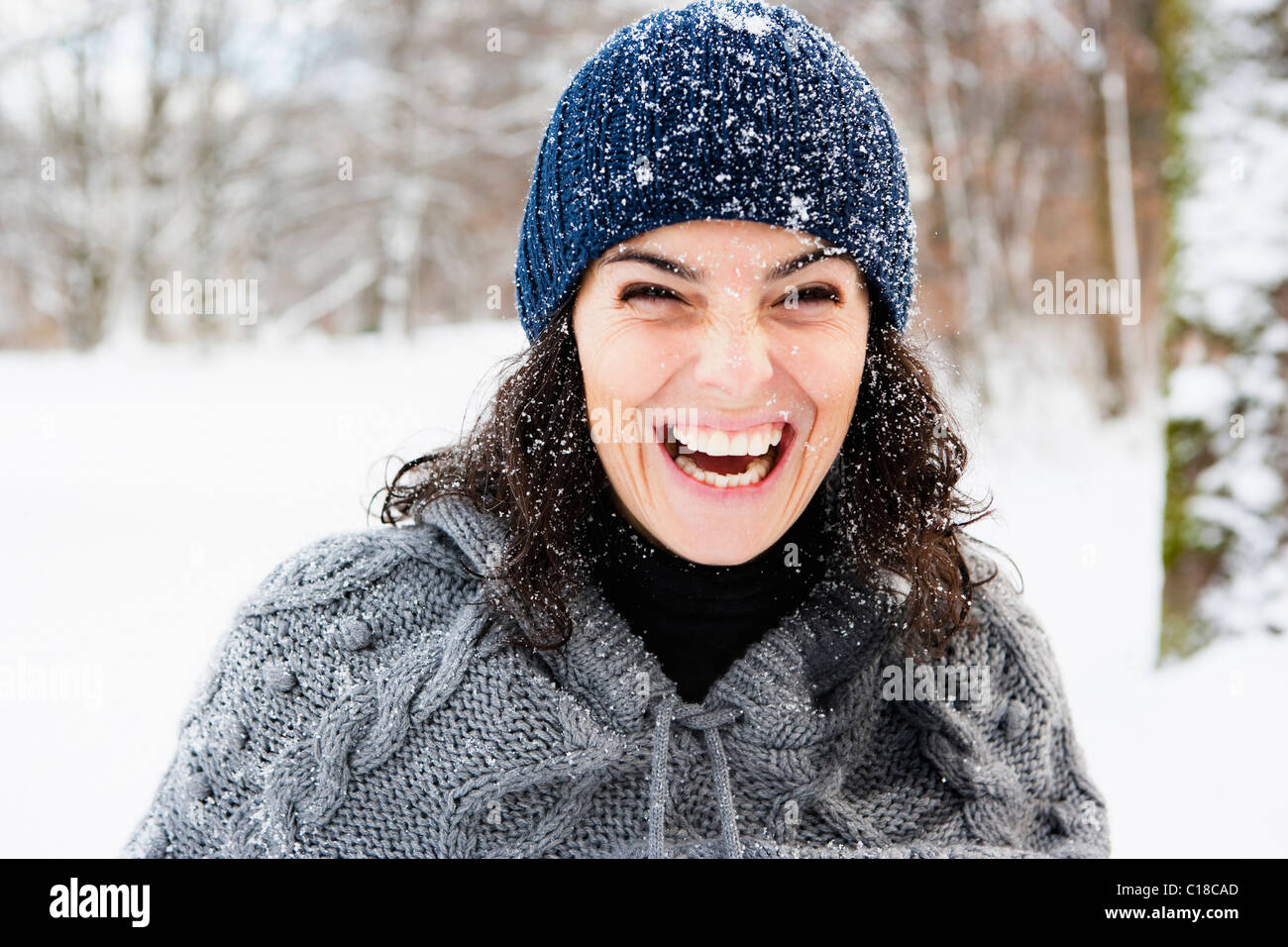 Woman in snow laughing Stock Photo - Alamy