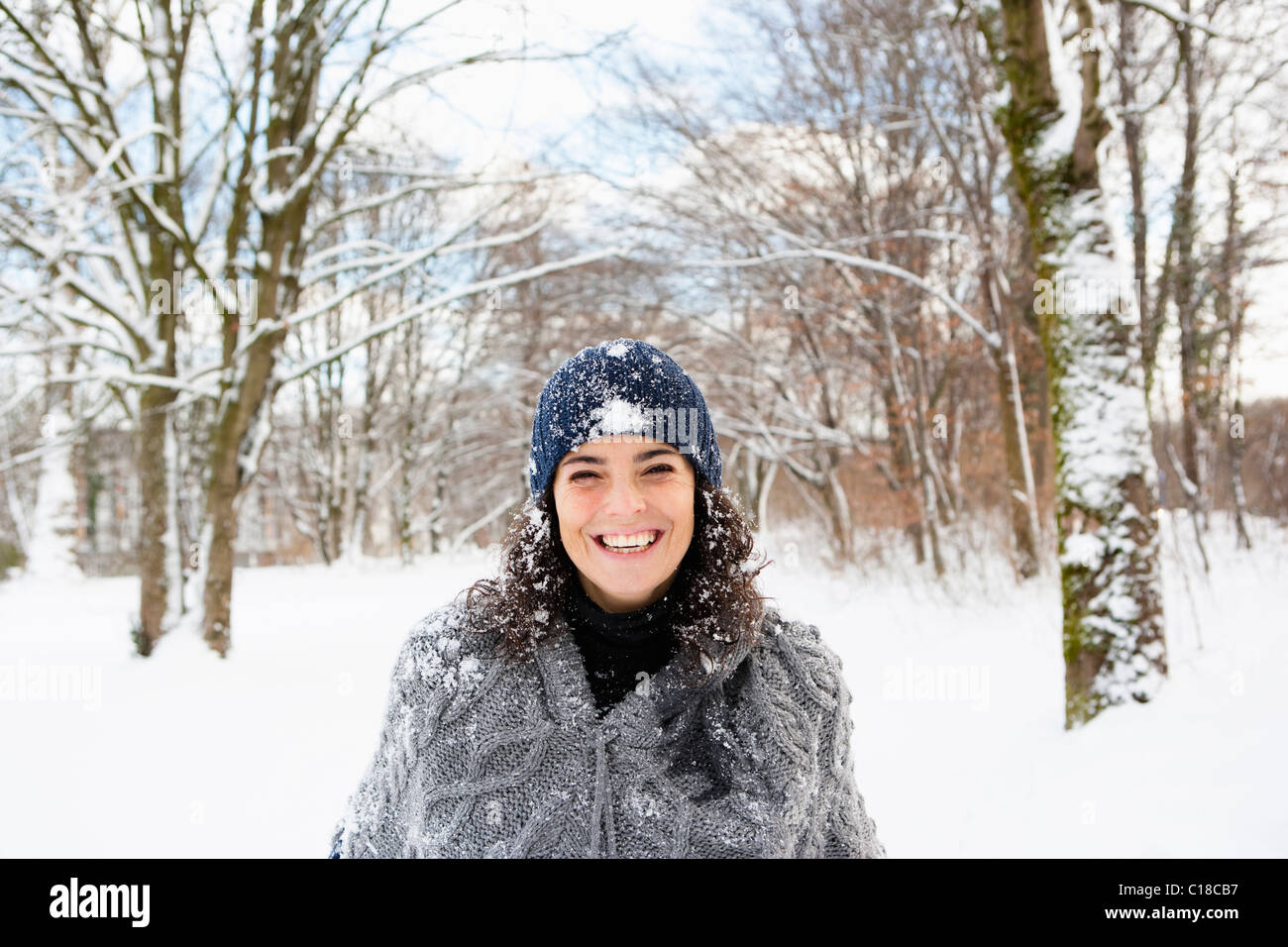 Woman taking a walk in snowy woods Stock Photo - Alamy
