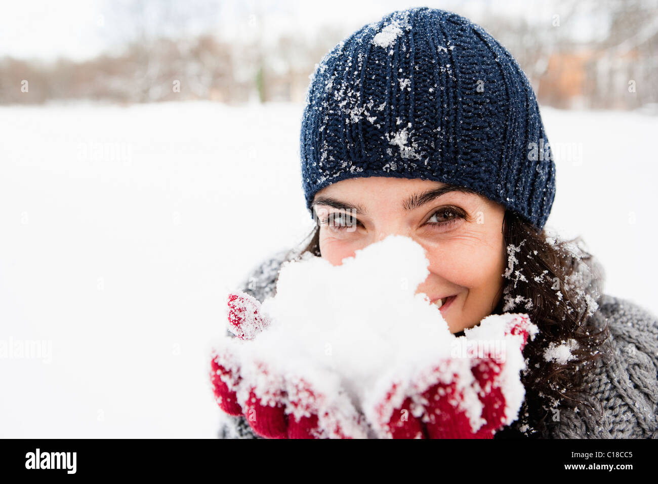 Woman holding snow in hands Stock Photo - Alamy