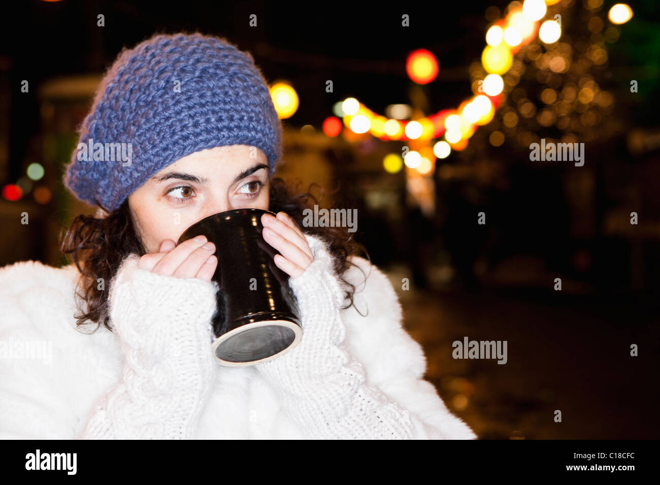 Woman drinking hot drink Stock Photo - Alamy