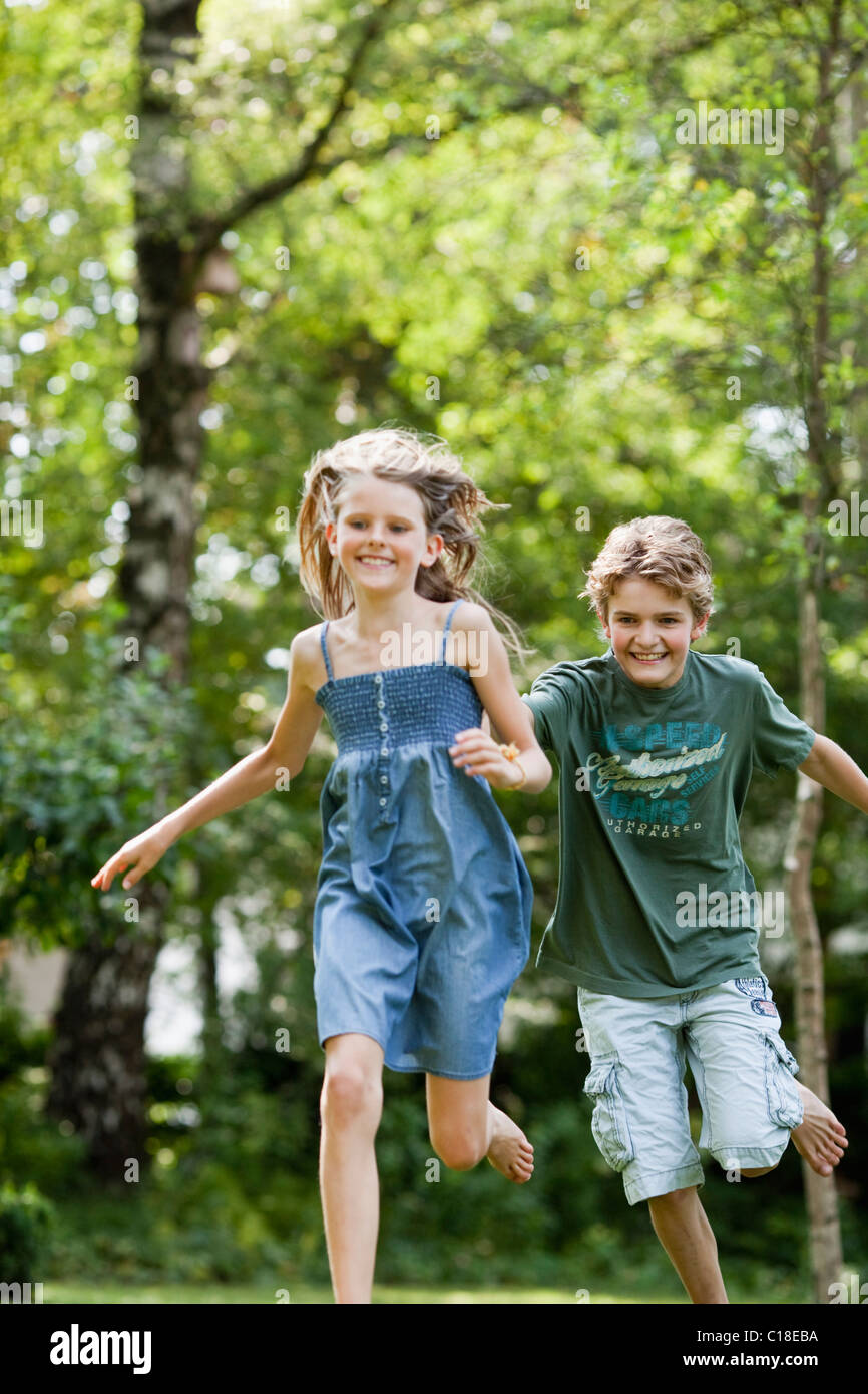 Boy chasing girl in garden Stock Photo - Alamy
