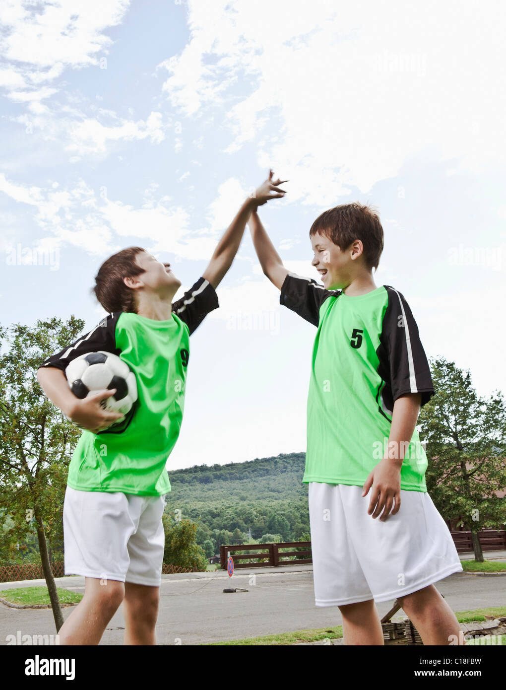Twin brothers high five Stock Photo - Alamy