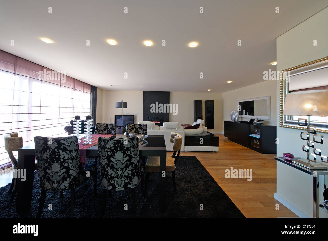 Modern spacious living room with dinning table Stock Photo - Alamy