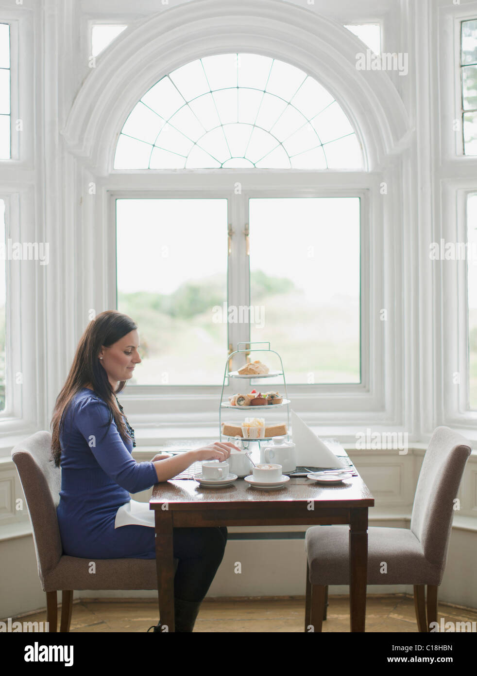 Woman having tea Stock Photo - Alamy